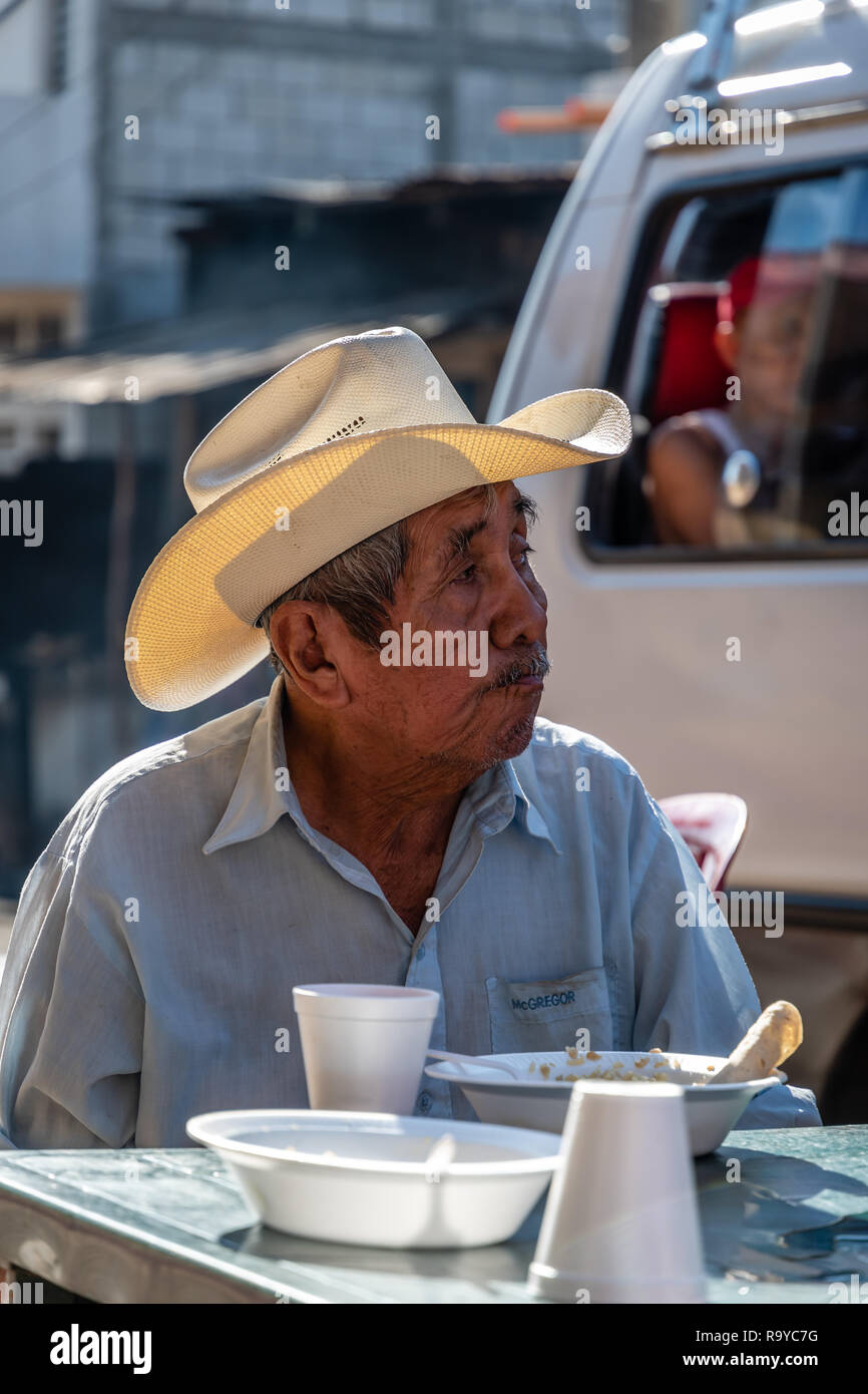 Guatemalan man eating on street Stock Photo - Alamy