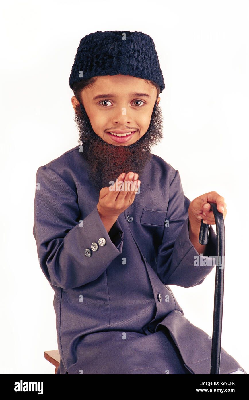 Muslim boy dressed in Traditional costume. Also wears a false moustache ...
