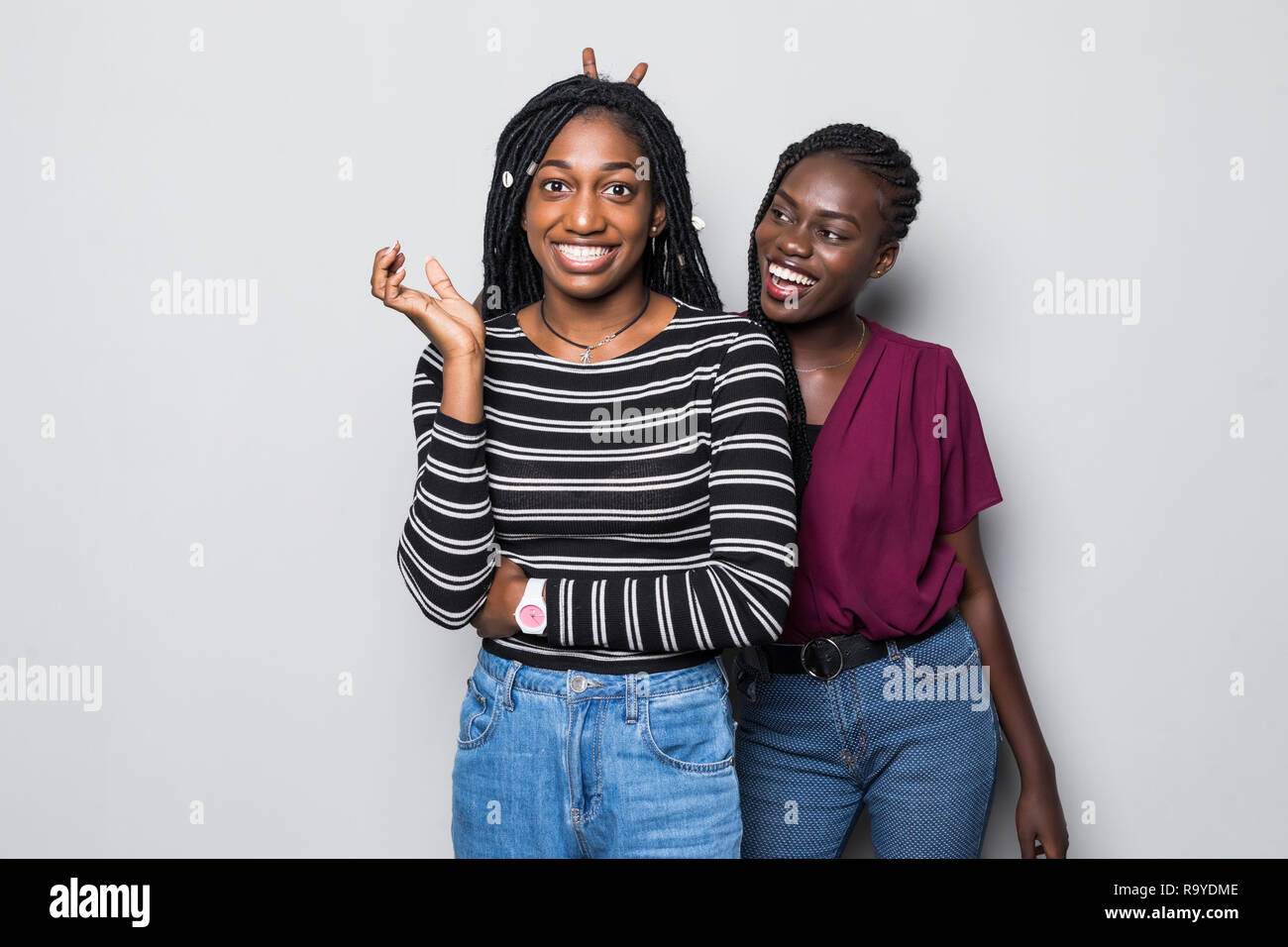 Two african woman make faces on camera on white background Stock Photo ...