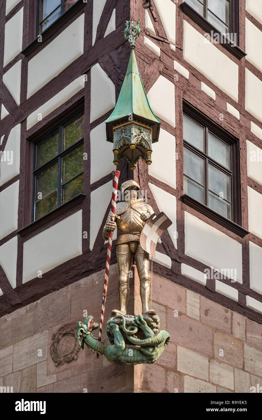 Saint George and the Dragon statue at half timbered building corner on ...