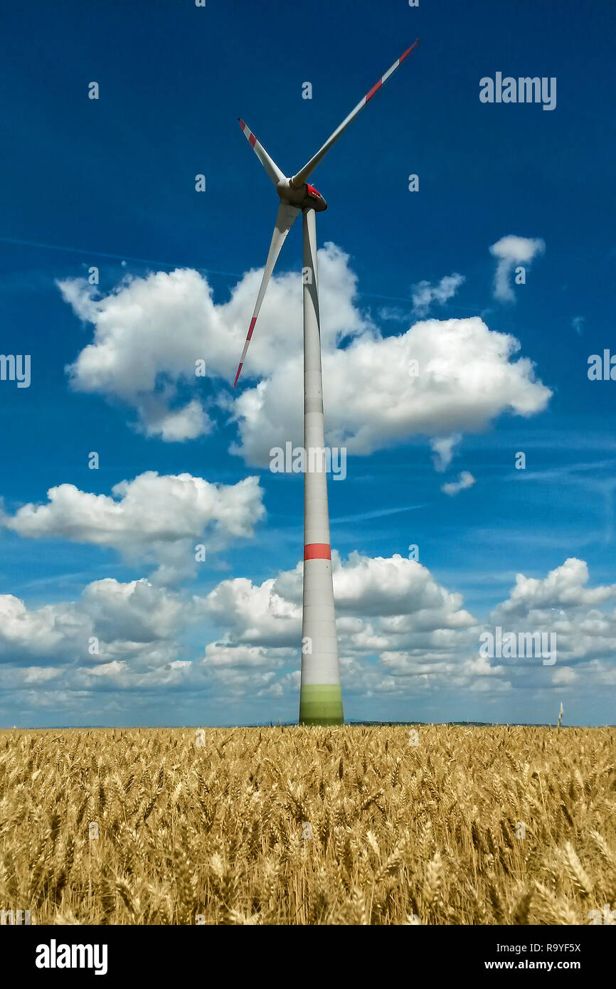 Wind Turbine in farmland under azure blue sky with cumulus cloud ...