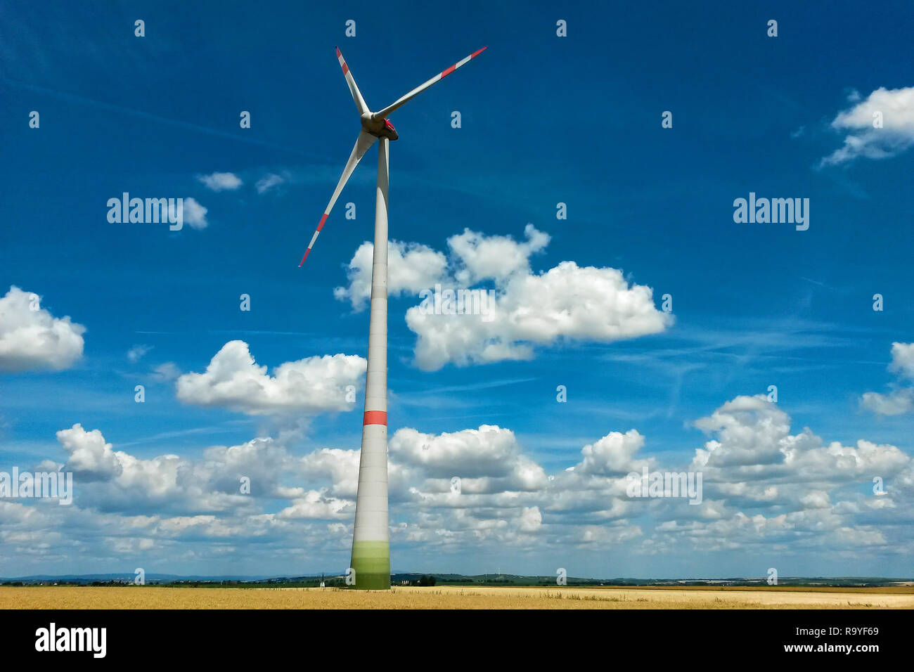 Wind Turbine in farmland under azure blue sky with cumulus cloud ...