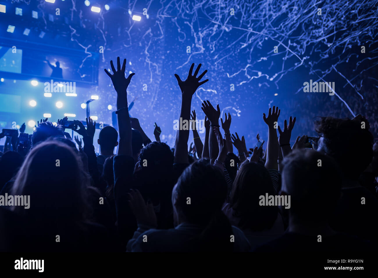 jumping people sing and have fun at a musical concert Stock Photo - Alamy