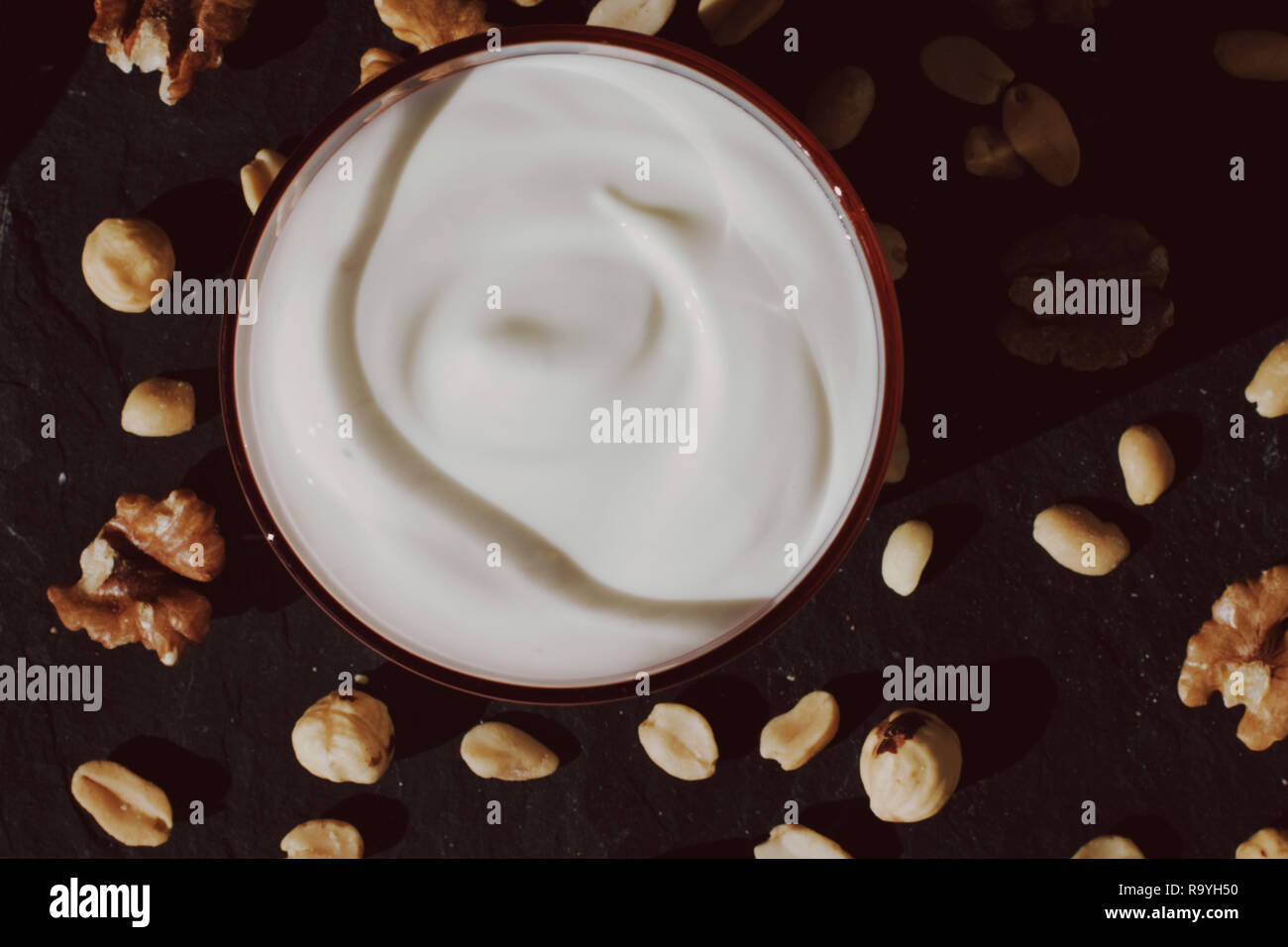 dairy and rustic farm food styled concept - fresh yogurt and nuts ...