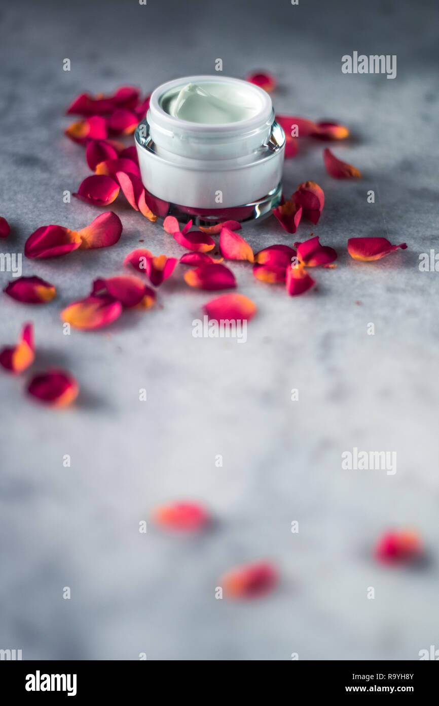 luxe face cream and rose petals - cosmetics with flowers styled beauty ...