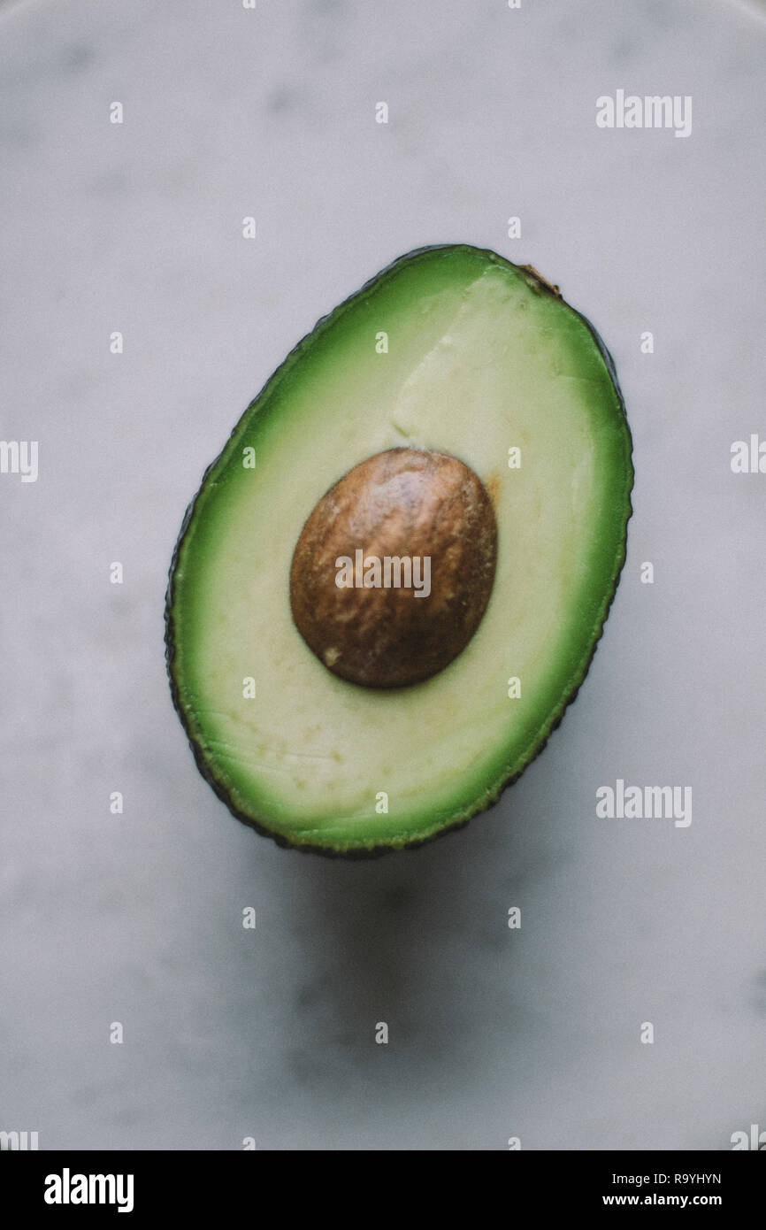 avocado on marble table - organic vegetables and healthy eating styled ...