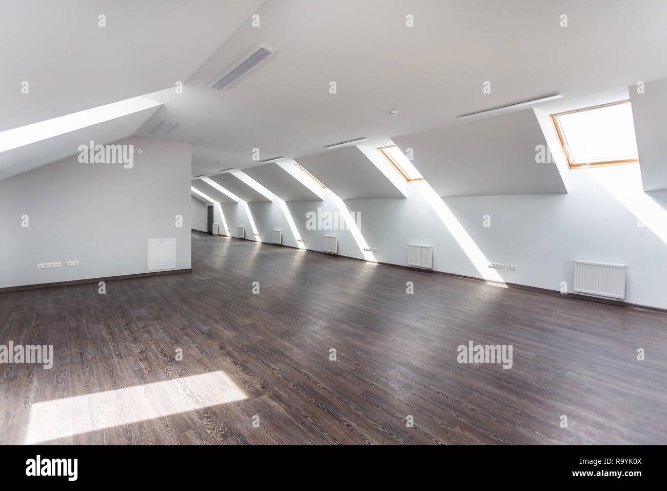 Side view of unfurnished room interior with wooden floor on roof floor ...