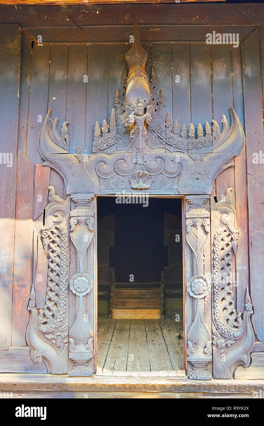 AVA, MYANMAR - FEBRUARY 21, 2018: The masterpiece carved door of Bagaya ...