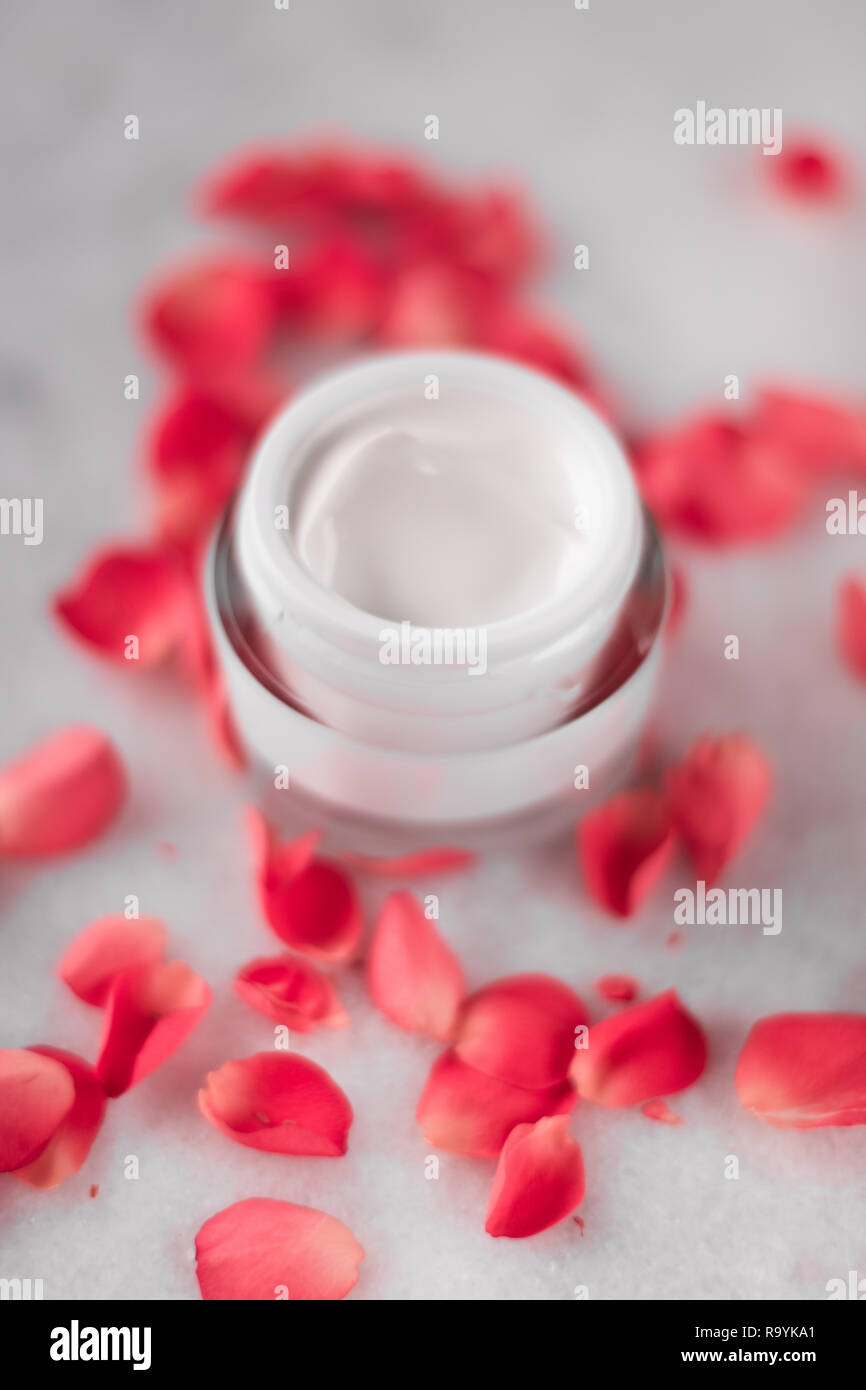 luxe face cream and rose petals - cosmetics with flowers styled beauty ...