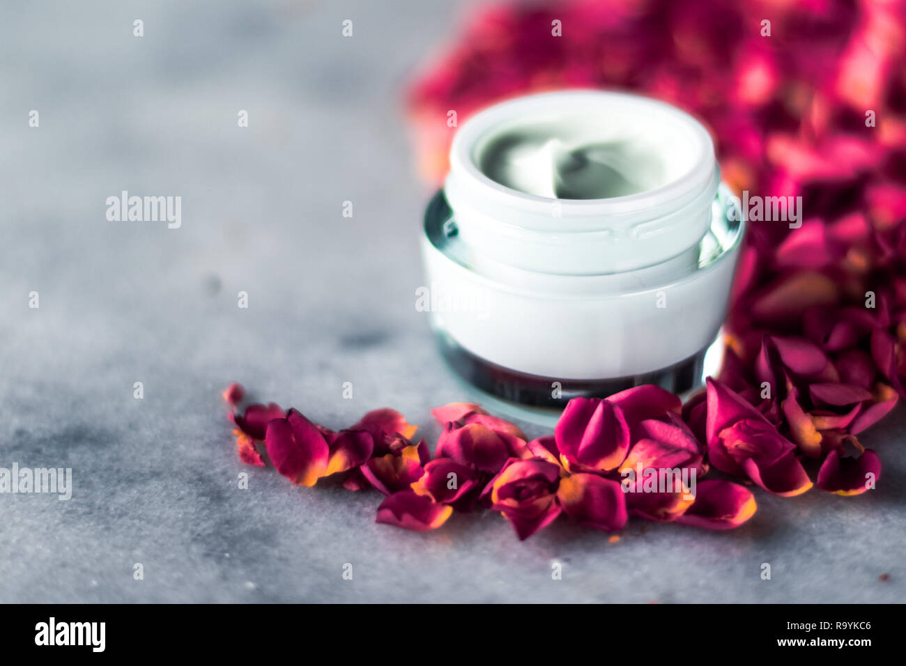 luxe face cream and rose petals - cosmetics with flowers styled beauty ...