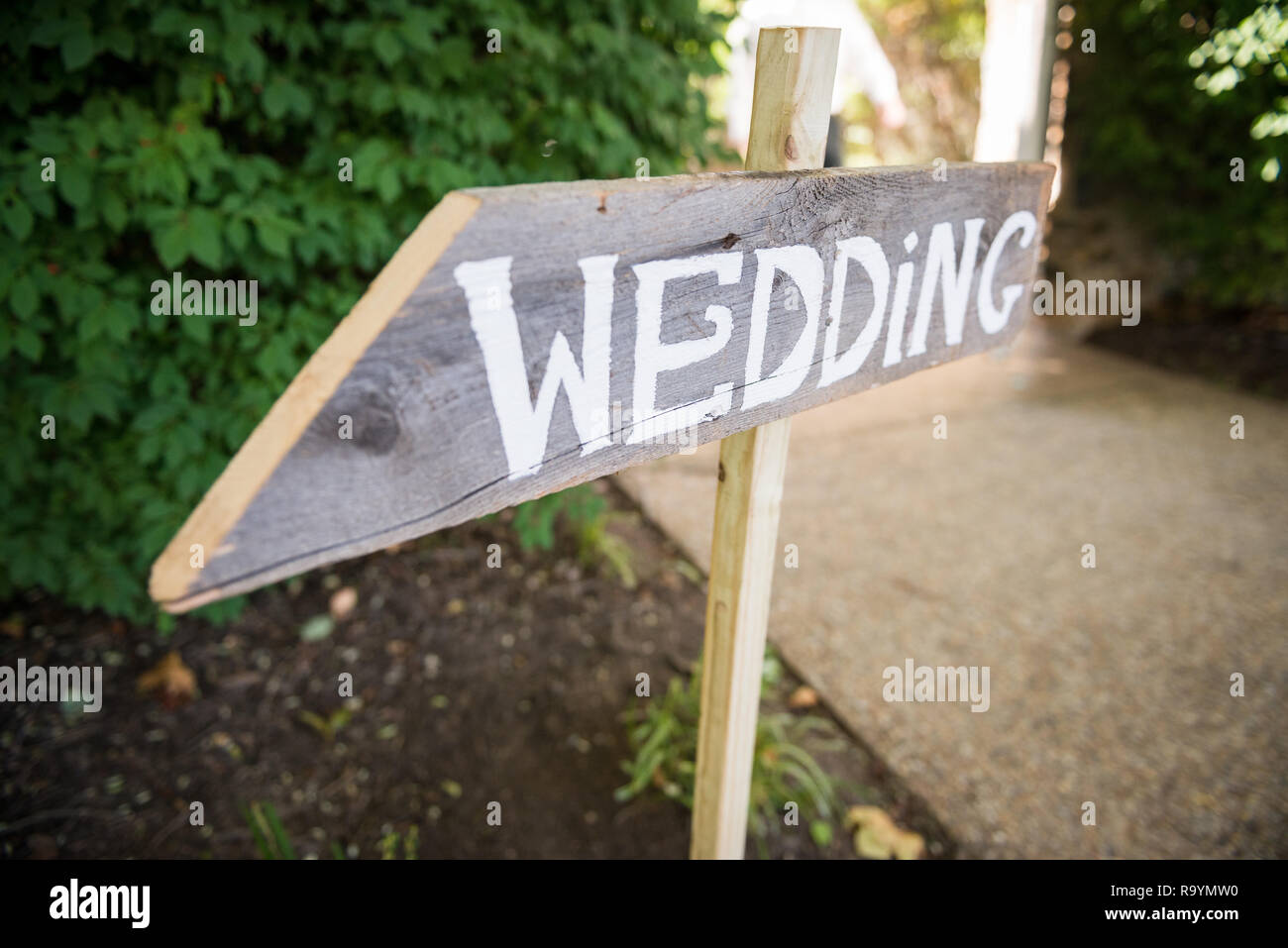 Rustic wooden wedding sign with white lettering on a directional arrow ...