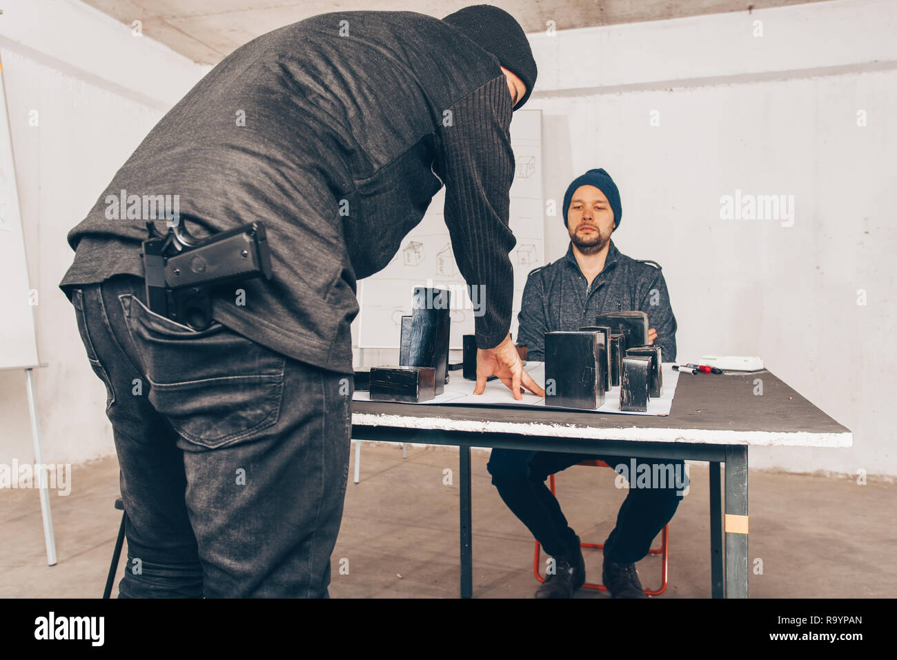 Male persons are sitting in a room with maps and they are preparing for ...