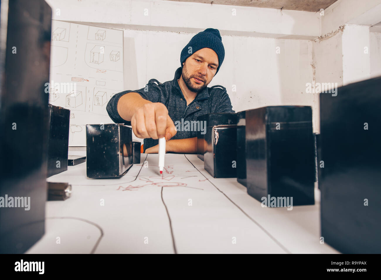 Young thief sitting in a room and planning a money heist Stock Photo ...