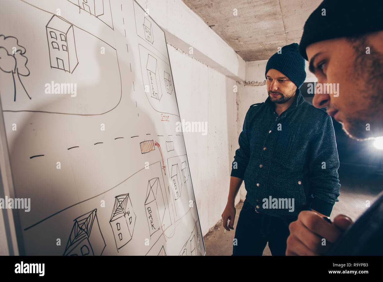 Two burglar planning robbery on map in the dark room Stock Photo - Alamy
