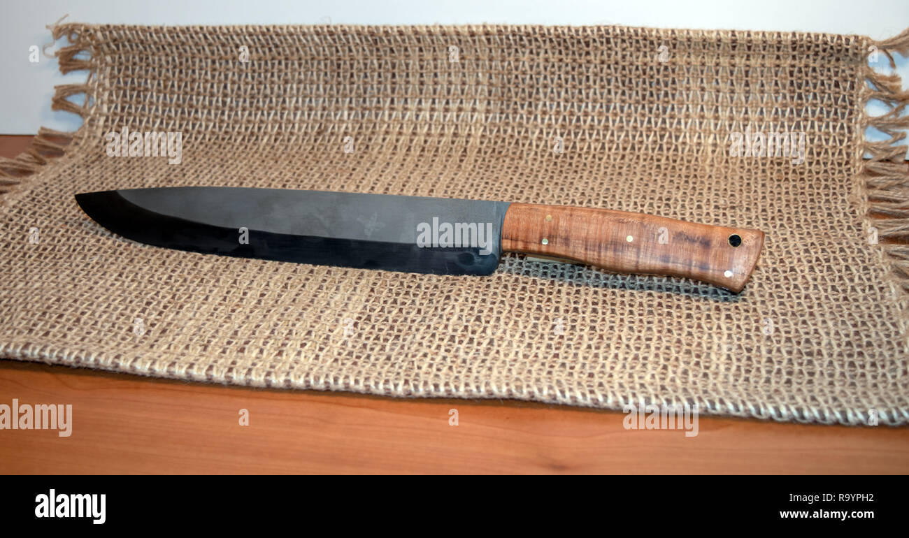 A handcrafted bowie knife with a heat treated blade creating a hamon ...