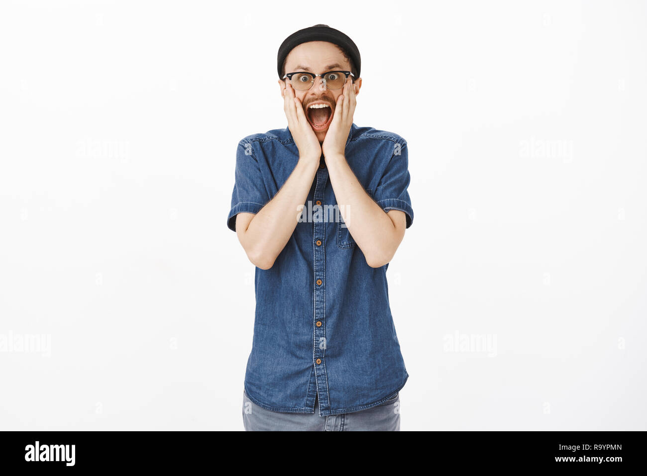 Fascinated male fan attending cool concert screaming from surprise and ...