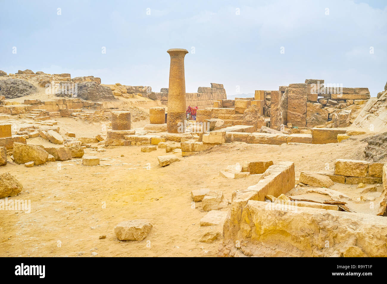 The ruins of Khufu's pyramid temple complex with preserved stone column ...