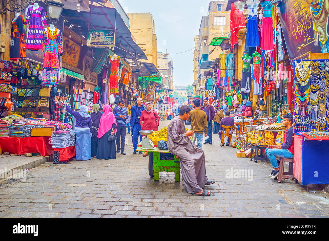 CAIRO, EGYPT - DECEMBER 20, 2017: The young merchant sells mandarins ...