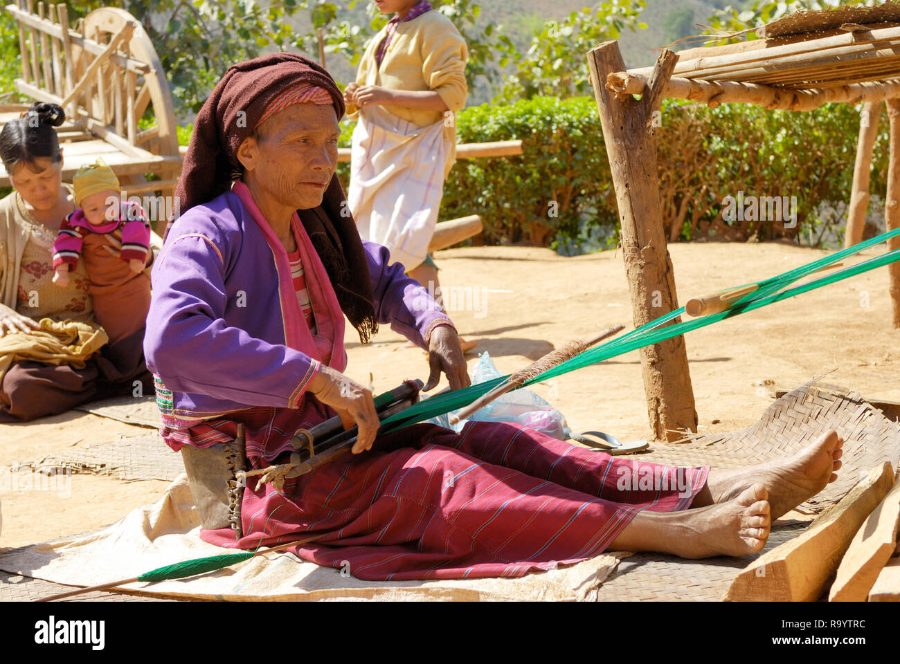woman weaves using a traditional loom, people of Palaung tribe, Kalaw ...