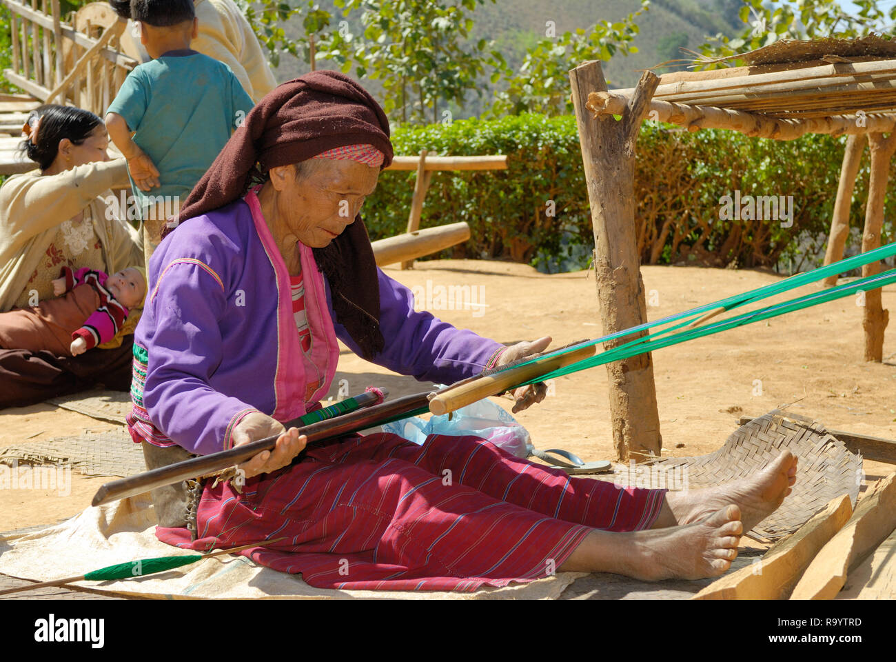 woman weaves using a traditional loom, people of Palaung tribe, Kalaw ...