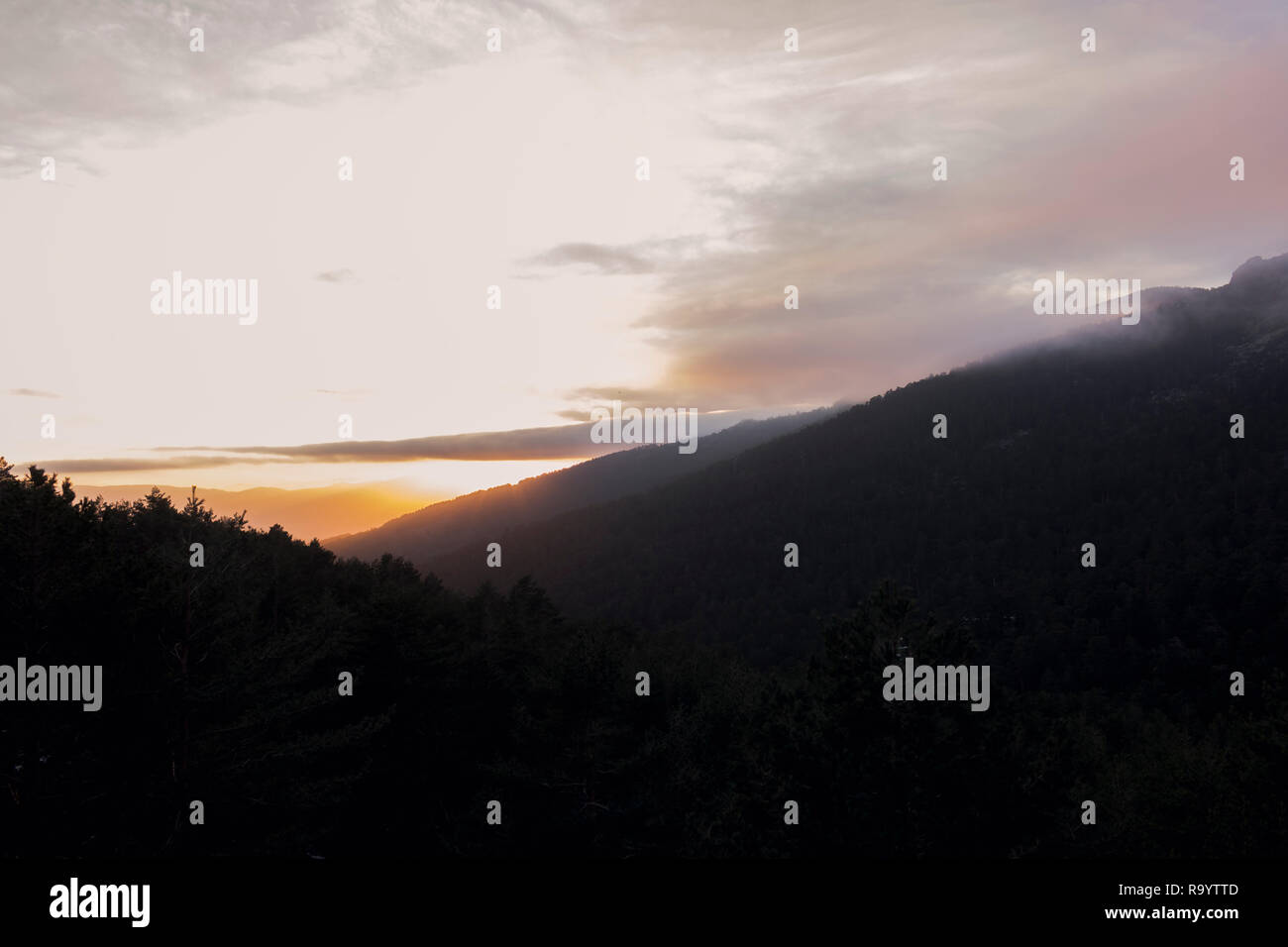 Nice sunset between mountains and wild forests Stock Photo - Alamy