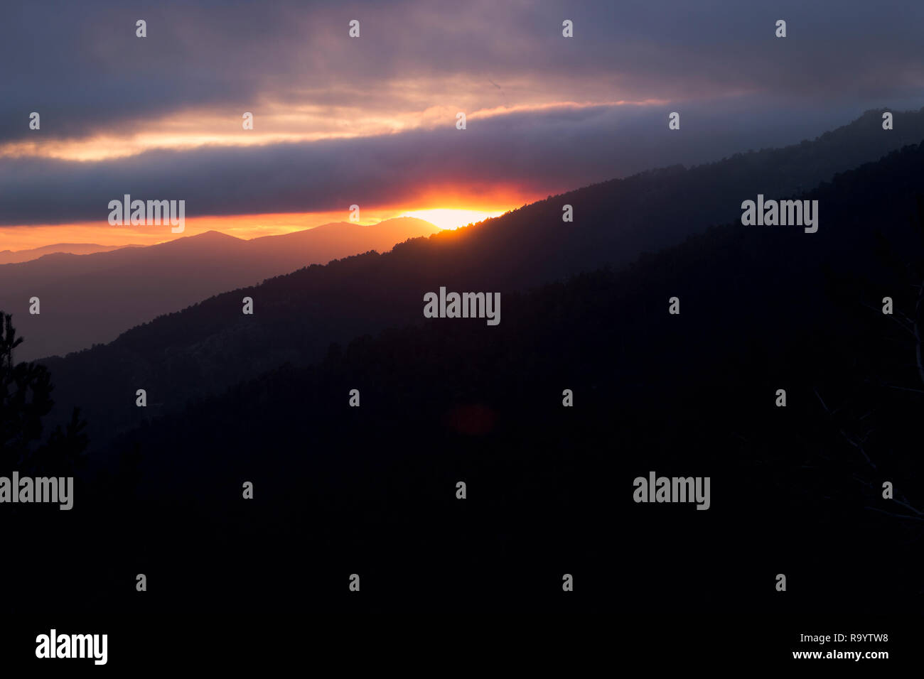 Nice sunset between mountains and wild forests Stock Photo - Alamy