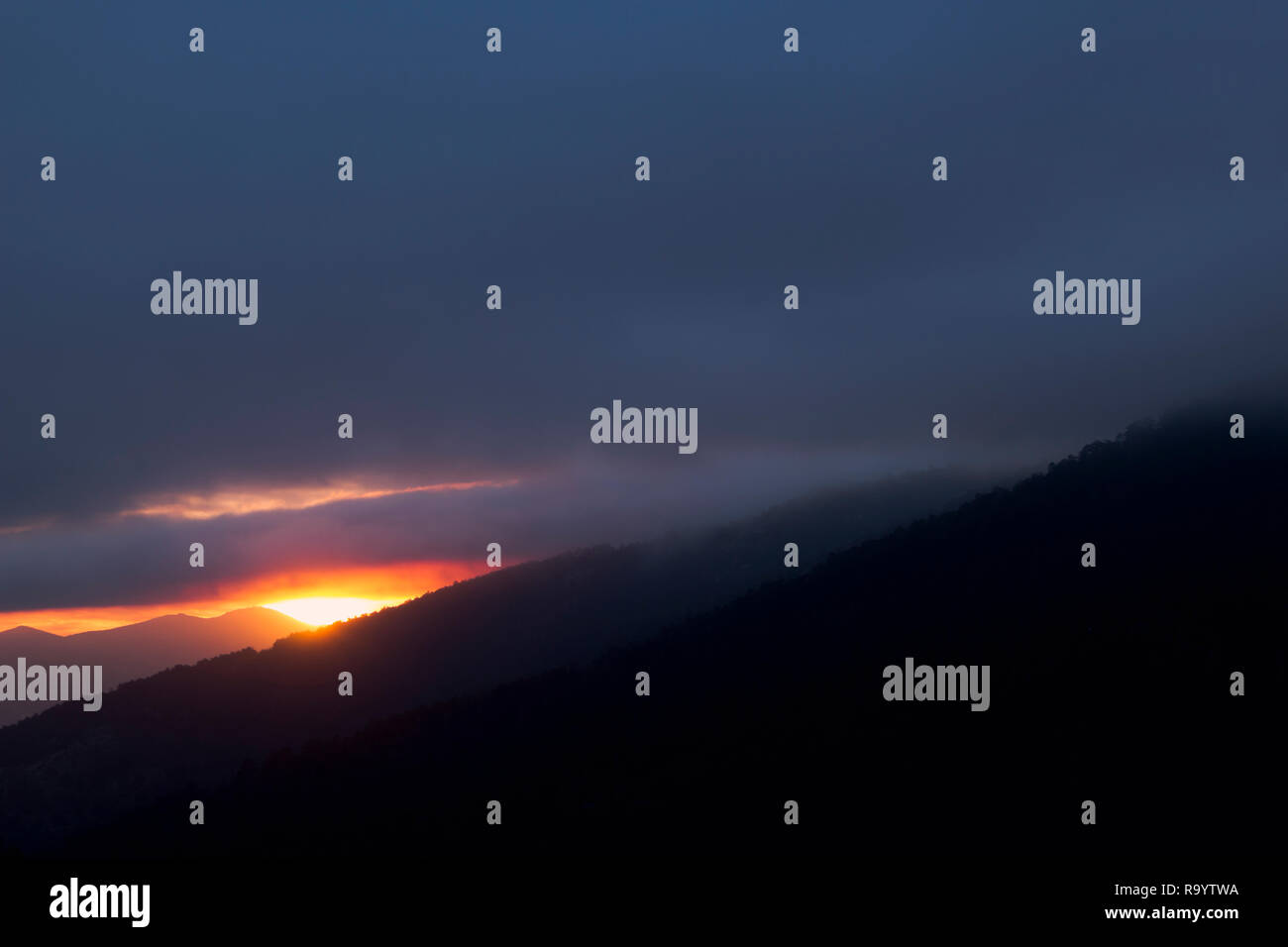 Nice sunset between mountains and wild forests Stock Photo - Alamy