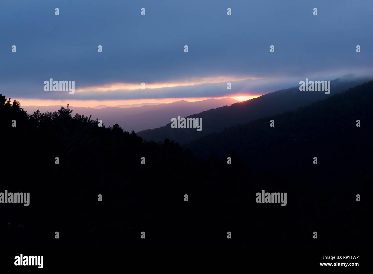 Nice sunset between mountains and wild forests Stock Photo - Alamy