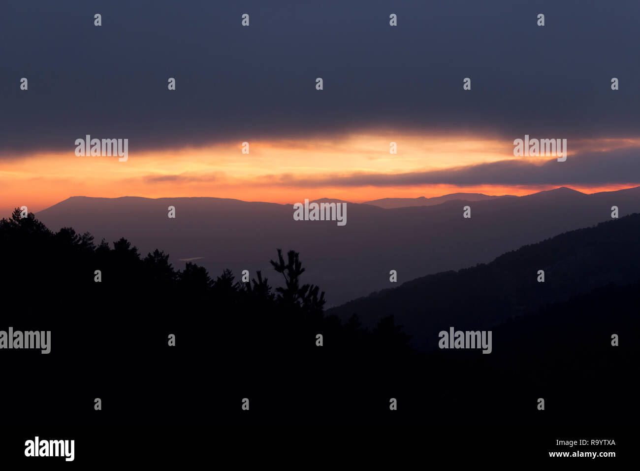 Nice sunset between mountains and wild forests Stock Photo - Alamy