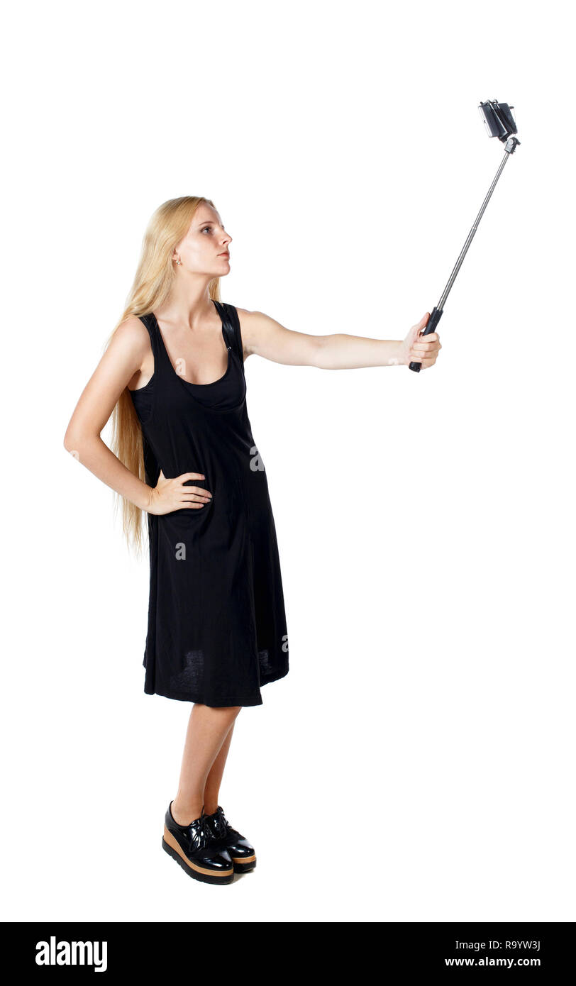 back view of standing young beautiful girl with tablet computer in the ...