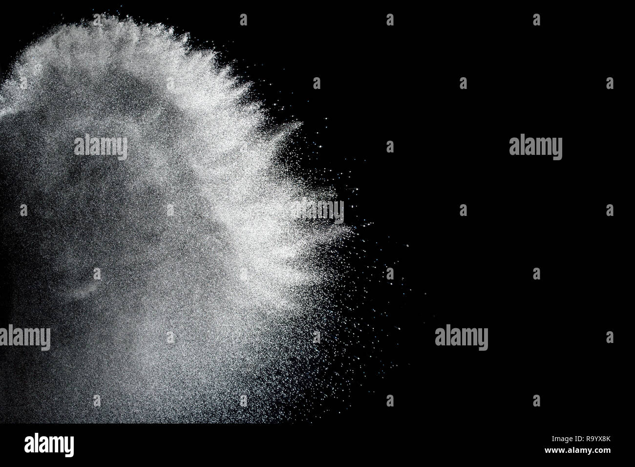 Freeze motion of white particles on black background. Powder explosion ...