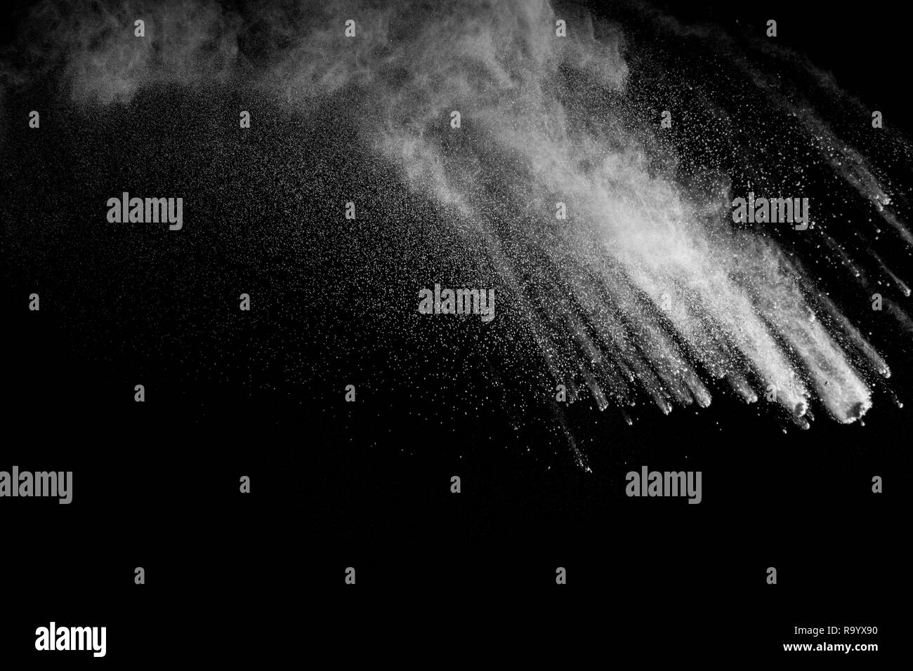 Launched white powder splash on black background Stock Photo - Alamy