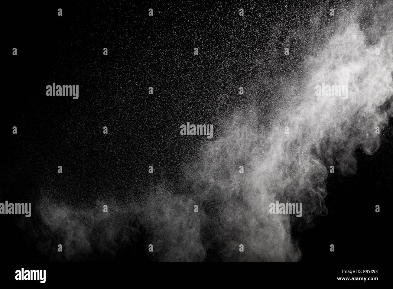 Launched white powder splash on black background Stock Photo - Alamy