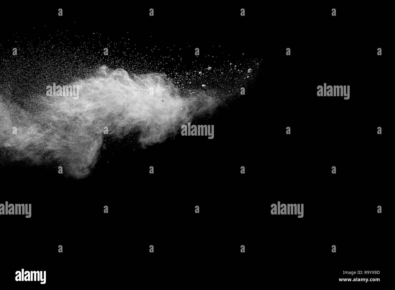 Launched white powder splash on black background Stock Photo - Alamy