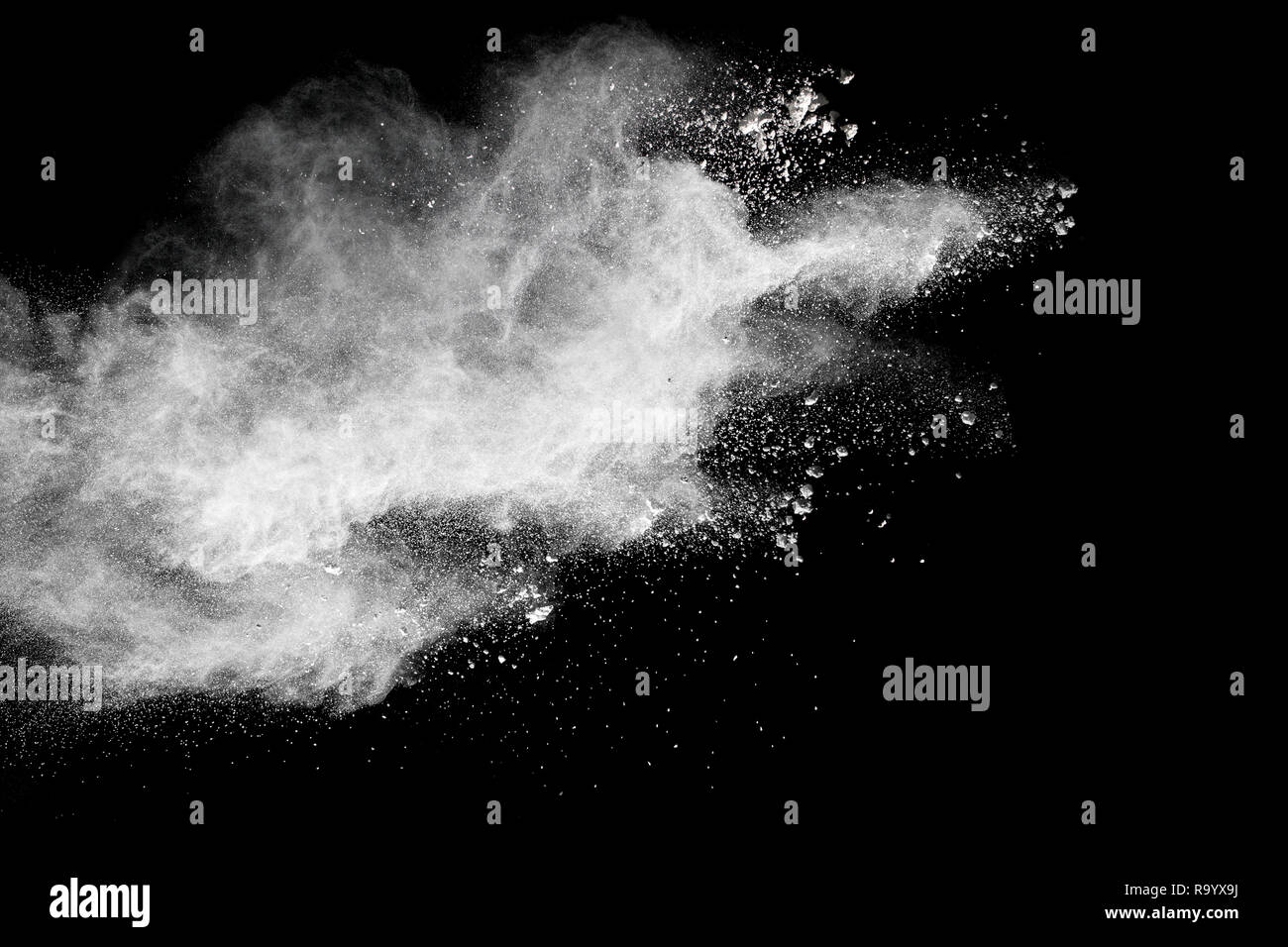 Launched white powder splash on black background Stock Photo - Alamy