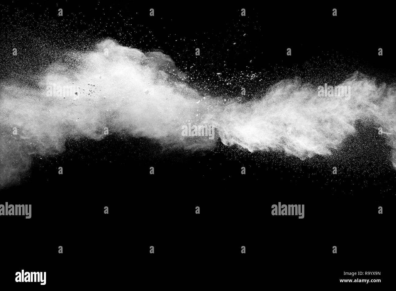 Launched white powder splash on black background Stock Photo - Alamy