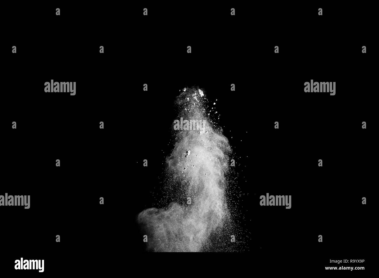 Launched white powder splash on black background Stock Photo - Alamy