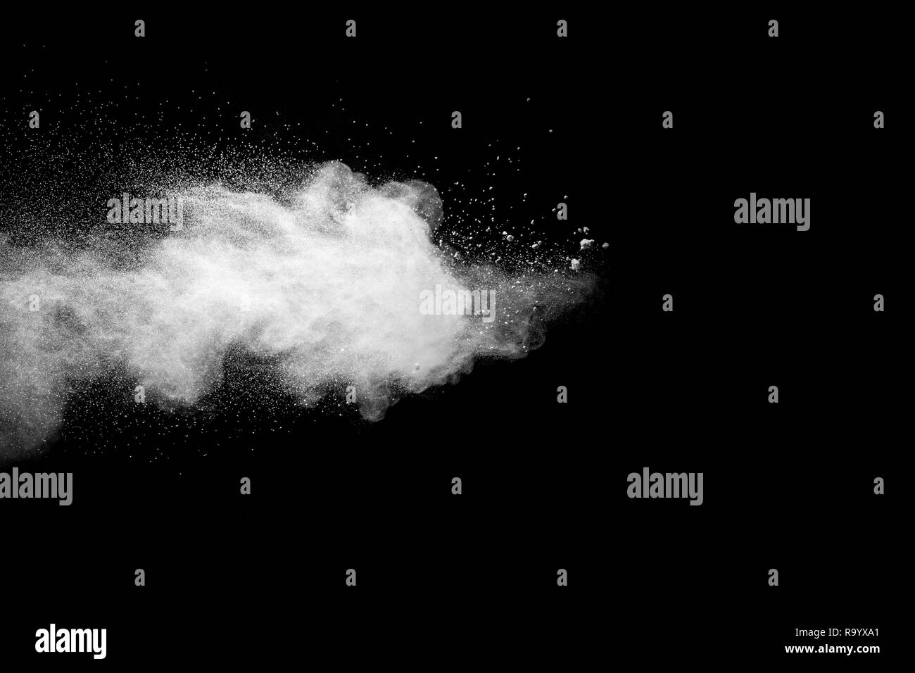 Launched white powder splash on black background Stock Photo - Alamy