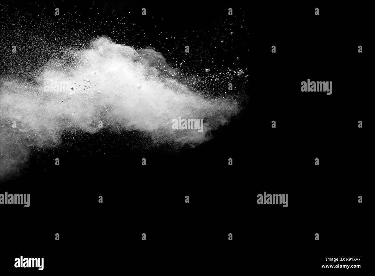 Launched white powder splash on black background Stock Photo - Alamy