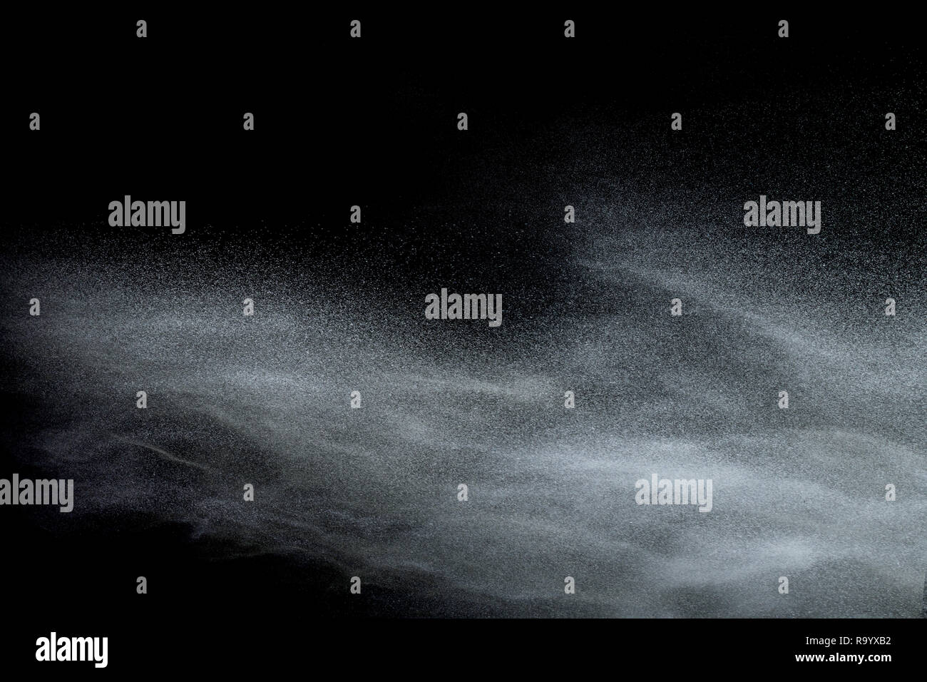 Bizarre forms of white powder explosion on white background.Launched ...