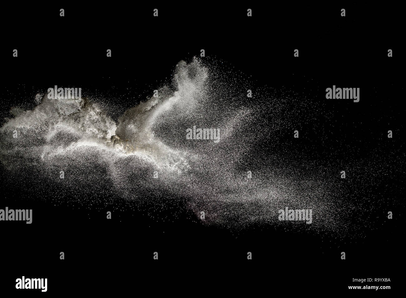 Bizarre forms of white powder explosion on white background.Launched ...