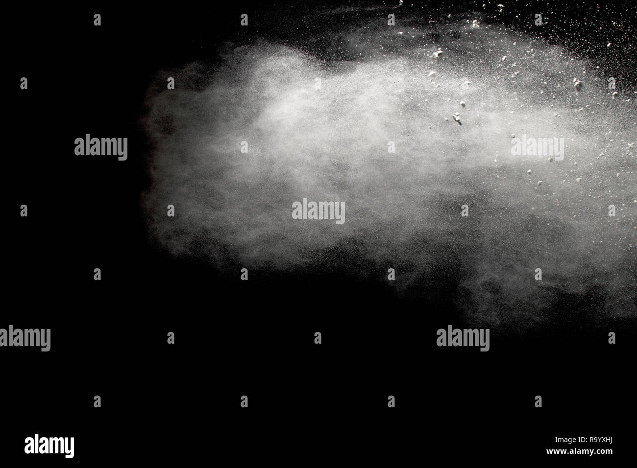 Bizarre forms of white powder explosion on white background.Launched ...