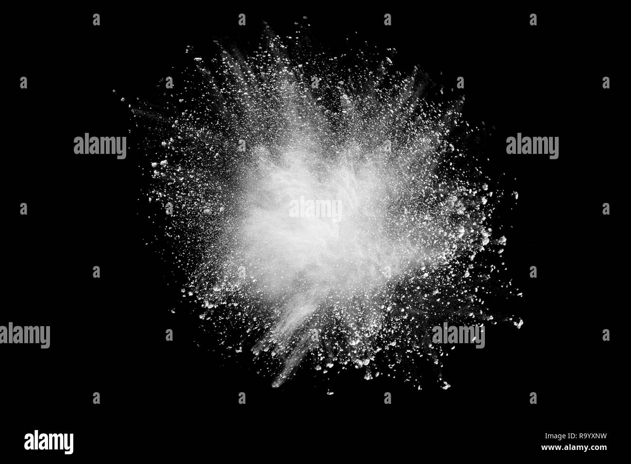 Bizarre forms of white powder explosion cloud against dark background ...