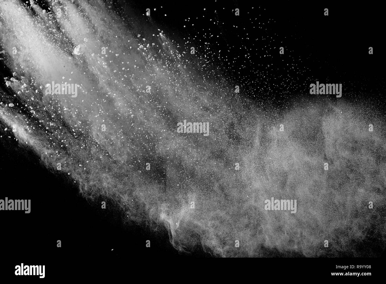 Bizarre forms of white powder explosion cloud against dark background ...