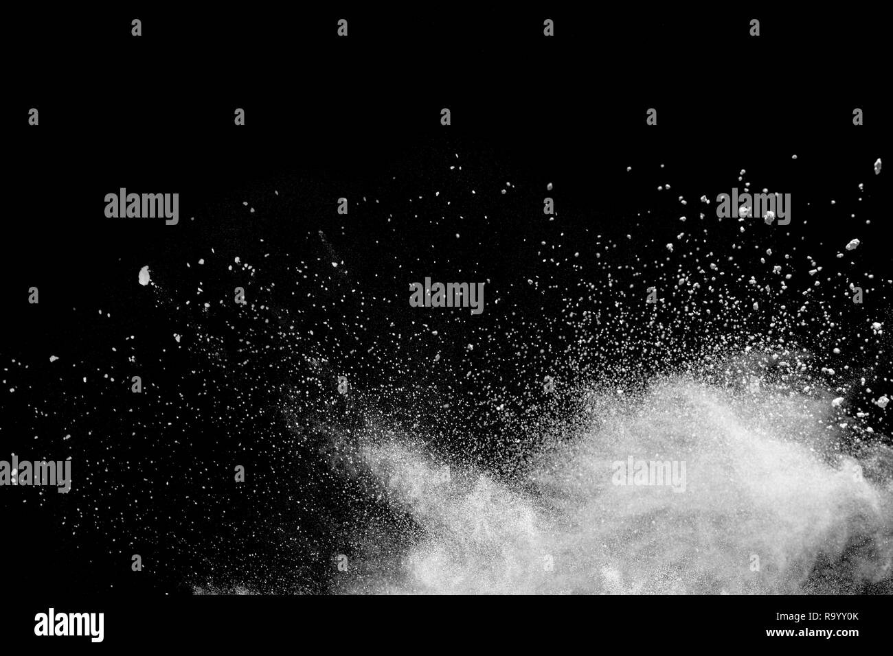 Bizarre forms of white powder explosion cloud against dark background ...