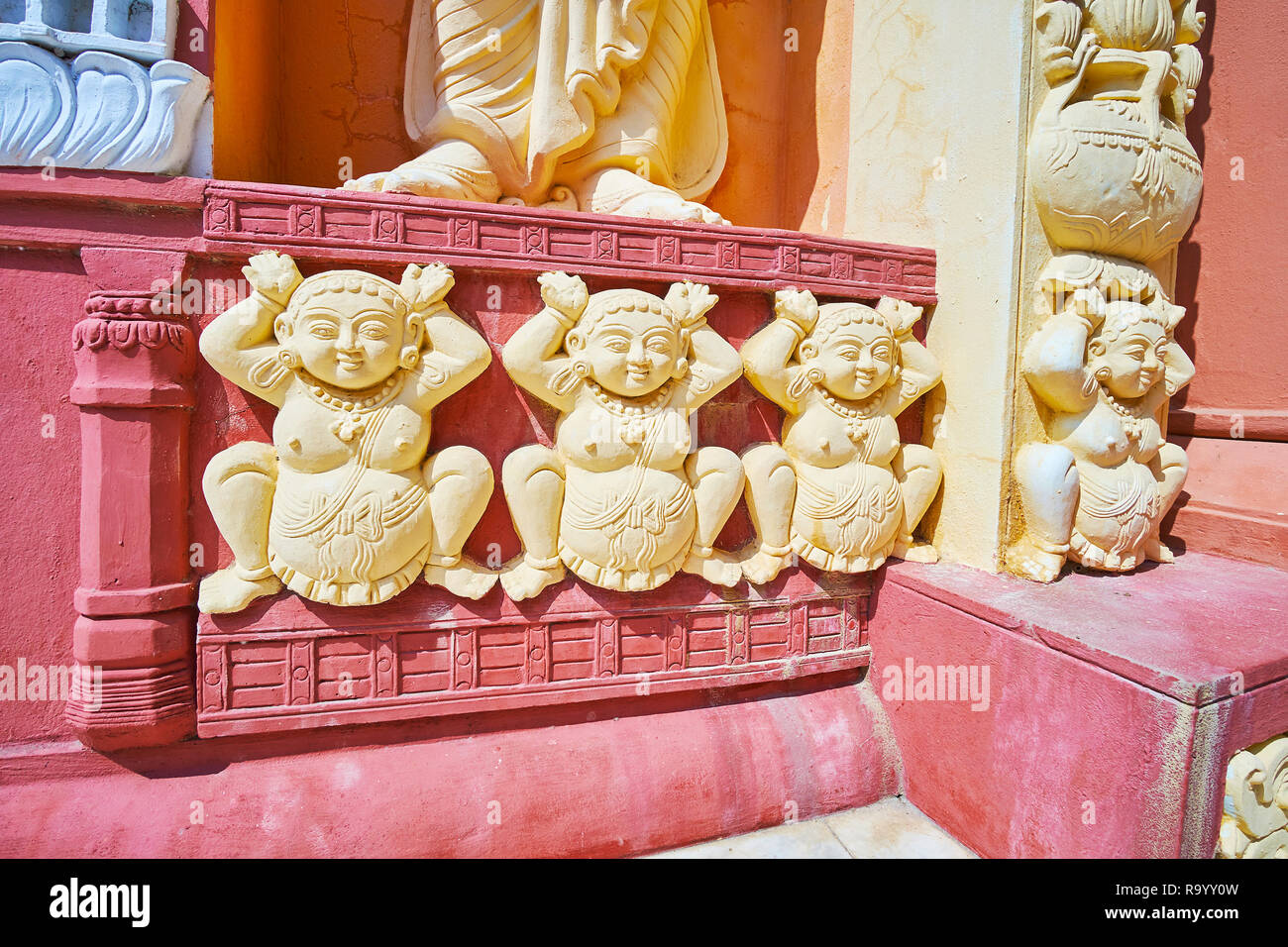 The wall sculptures of mythical dwarves decorate the pagoda of Sitagu ...
