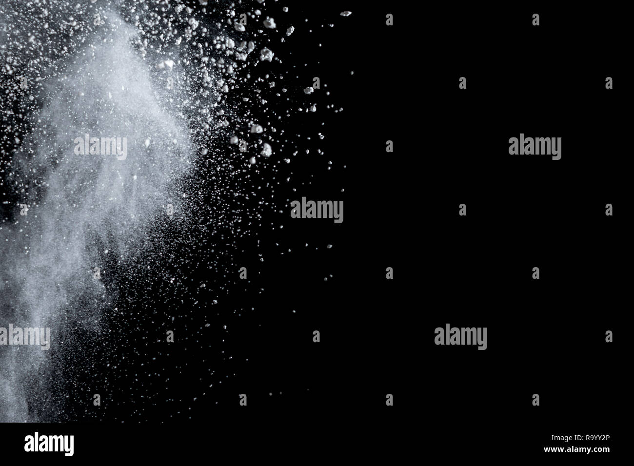 Bizarre forms of white powder explosion cloud against dark background ...