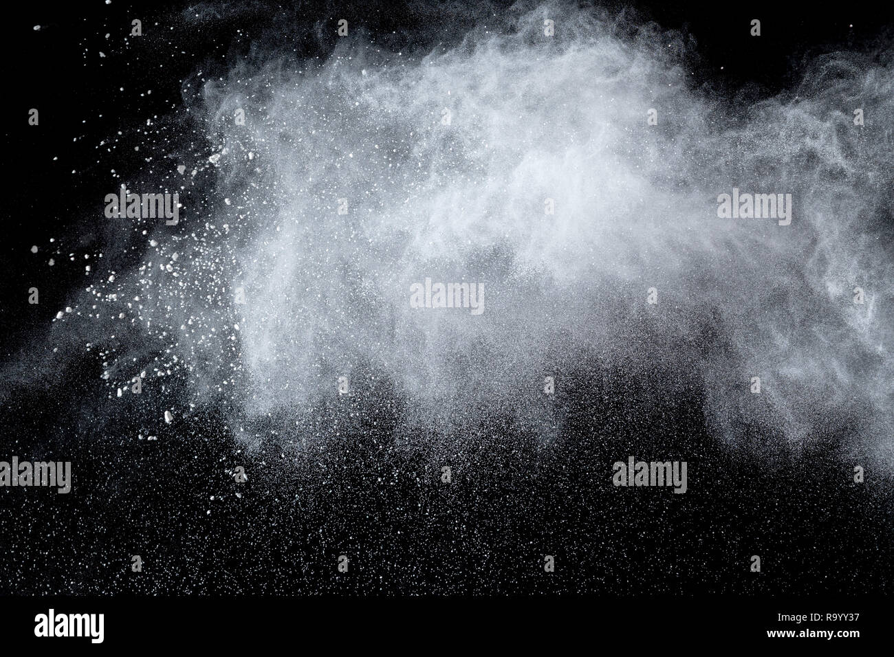 Bizarre forms of white powder explosion cloud against dark background ...
