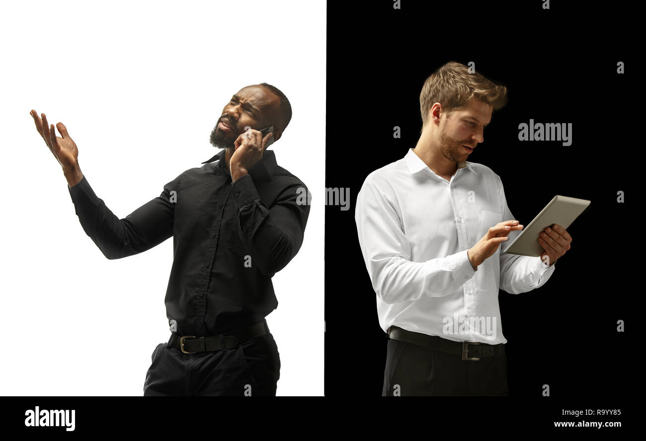 The success happy afro and caucasian men. Mixed couple with gadget ...