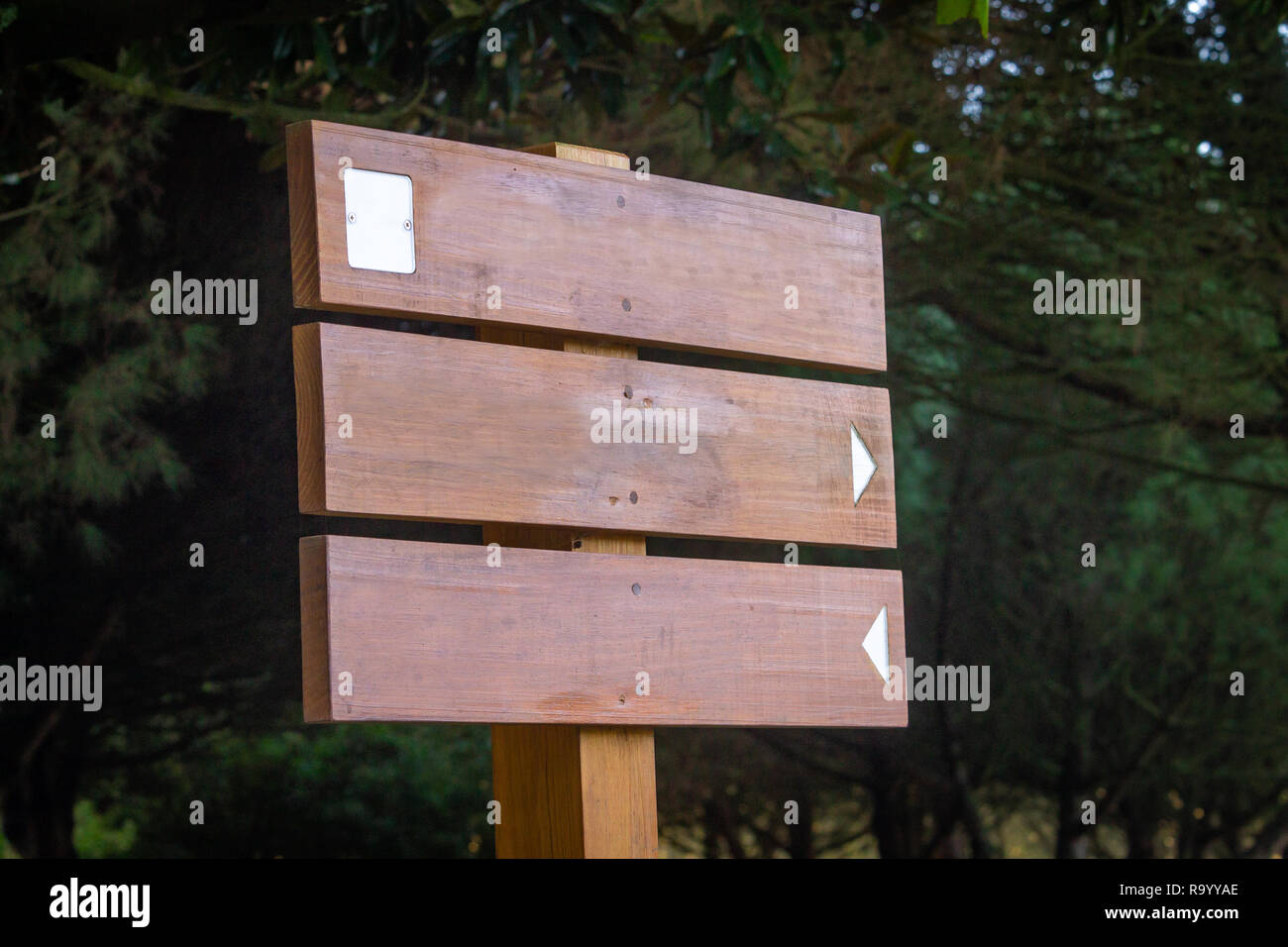 Side view of a wooden sign mockup with two signaling arrows and a white ...